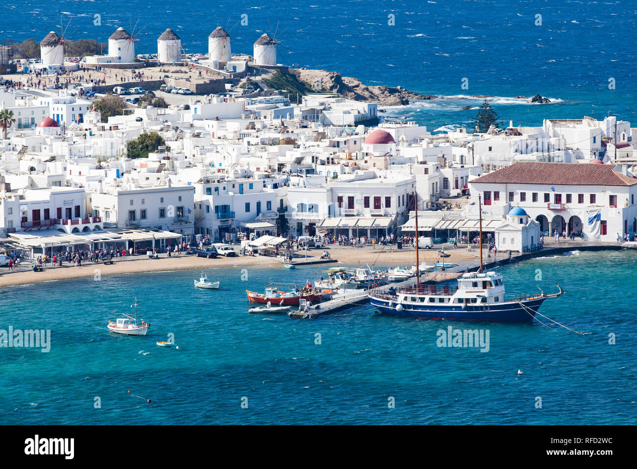 panoramic view of the Mykonos town harbor with famous windmills from ...