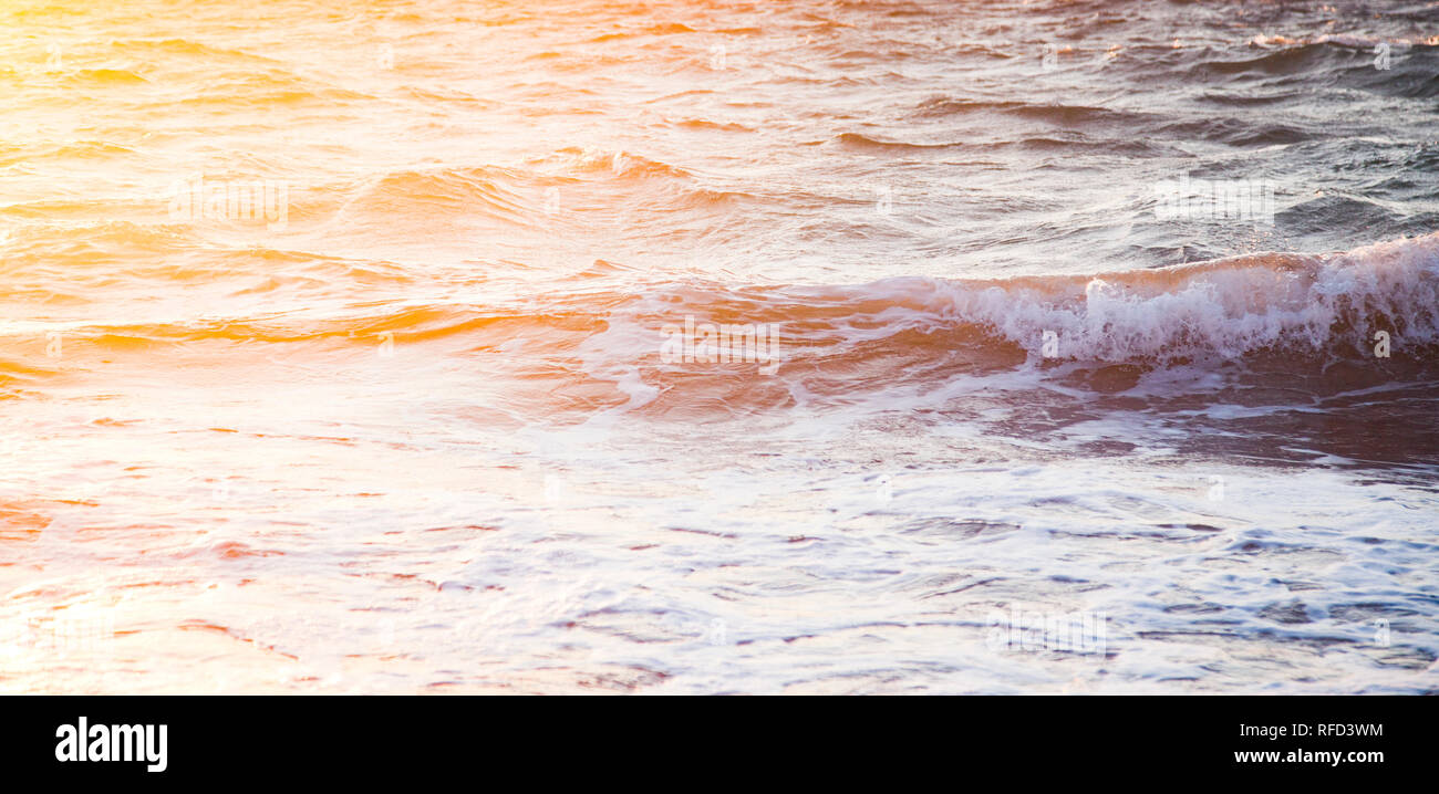 beautiful sea waves at sunset - beach holiday background Stock Photo ...