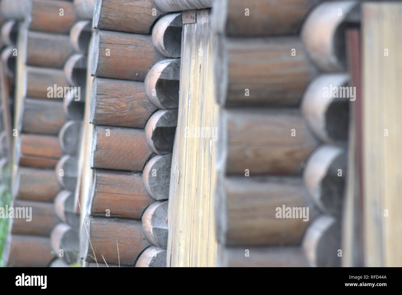A wooden fence made of logs in medieval style shot from a side view ...