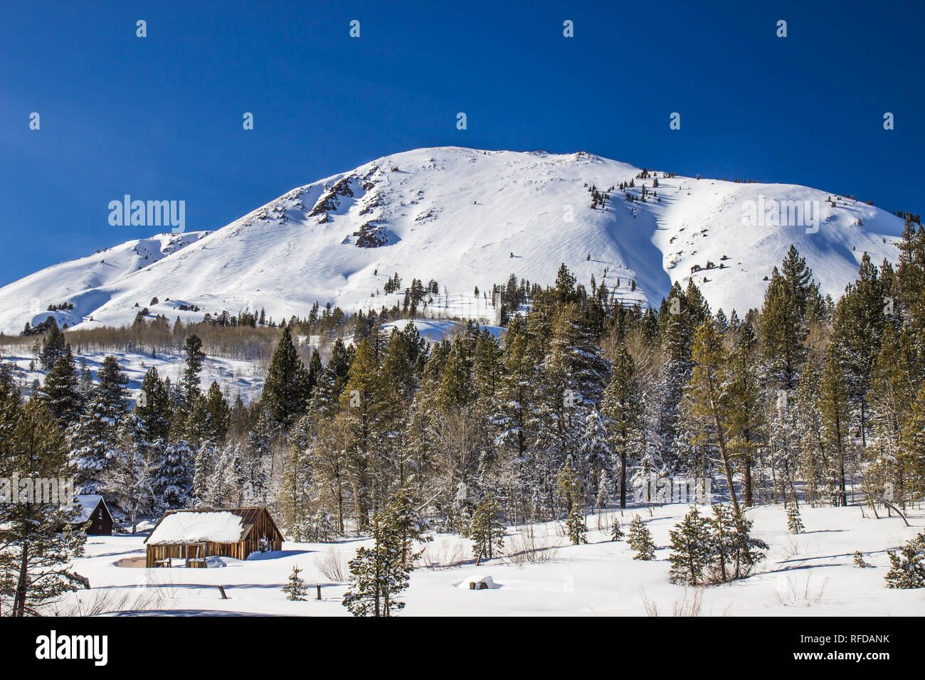 Small Cabins At Base Of Snow Covered Mountains Stock Photo - Alamy
