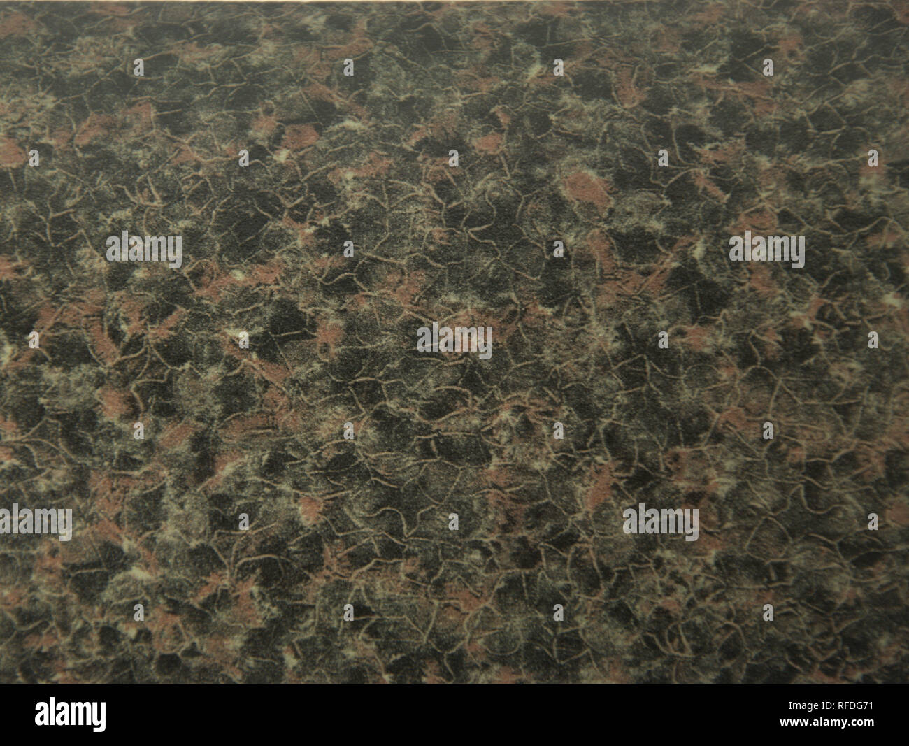 Natural stone granite of black-brown color with dark maroon ...
