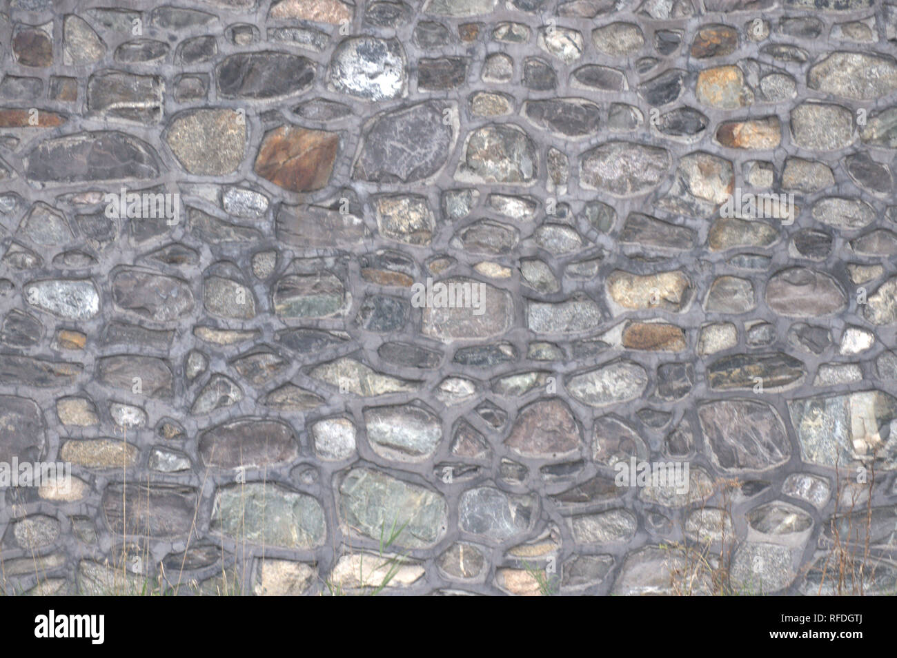 A high fence made of natural stone on a cement binder Close-up Stock ...