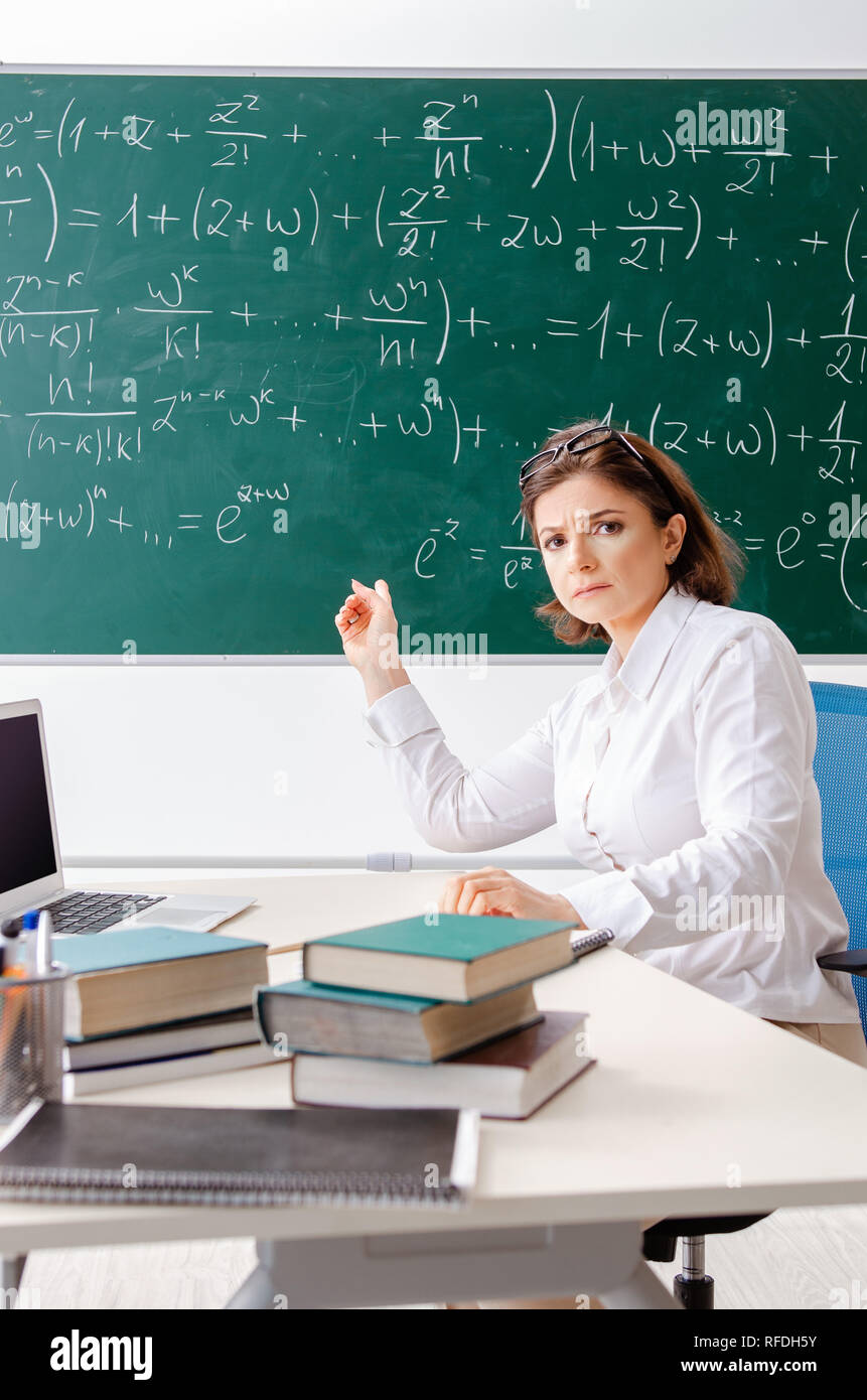 Maths teacher explaining mathematics formulas hi-res stock photography ...