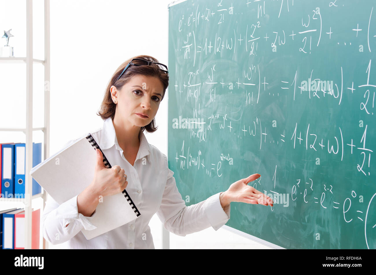 Female math teacher in front of the chalkboard Stock Photo - Alamy