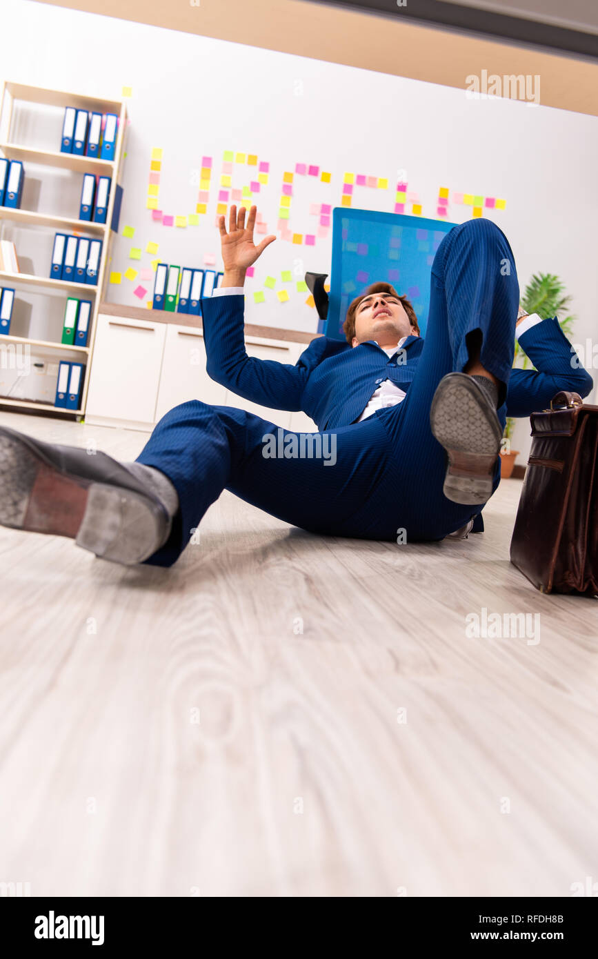 Young employee suffering from excessive work Stock Photo - Alamy