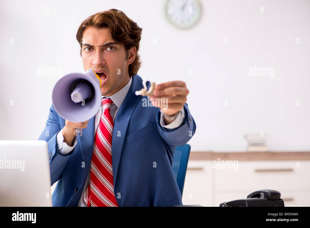 Deaf employee using hearing aid in office Stock Photo - Alamy