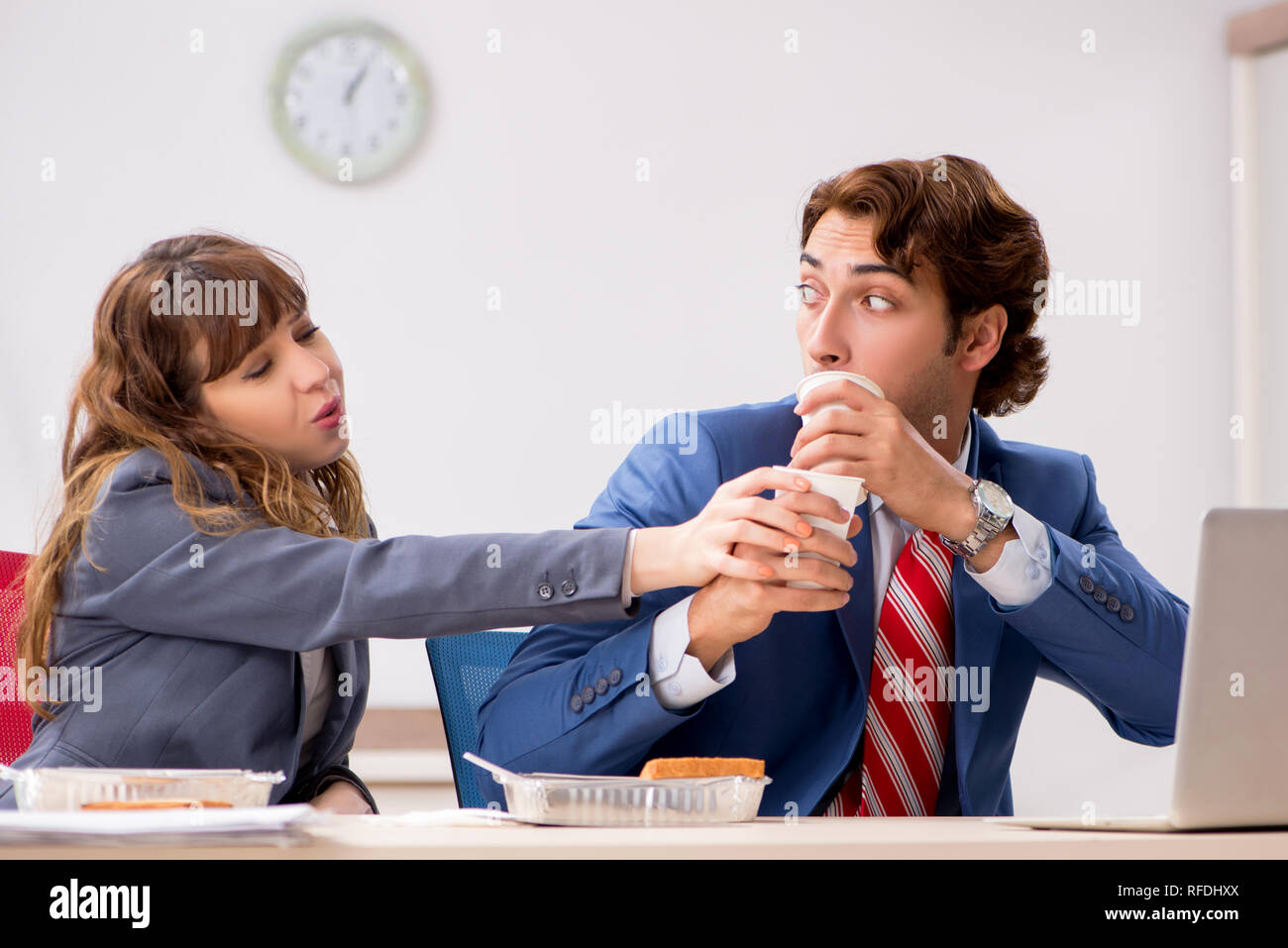 Two colleagues having lunch break at workplace Stock Photo - Alamy