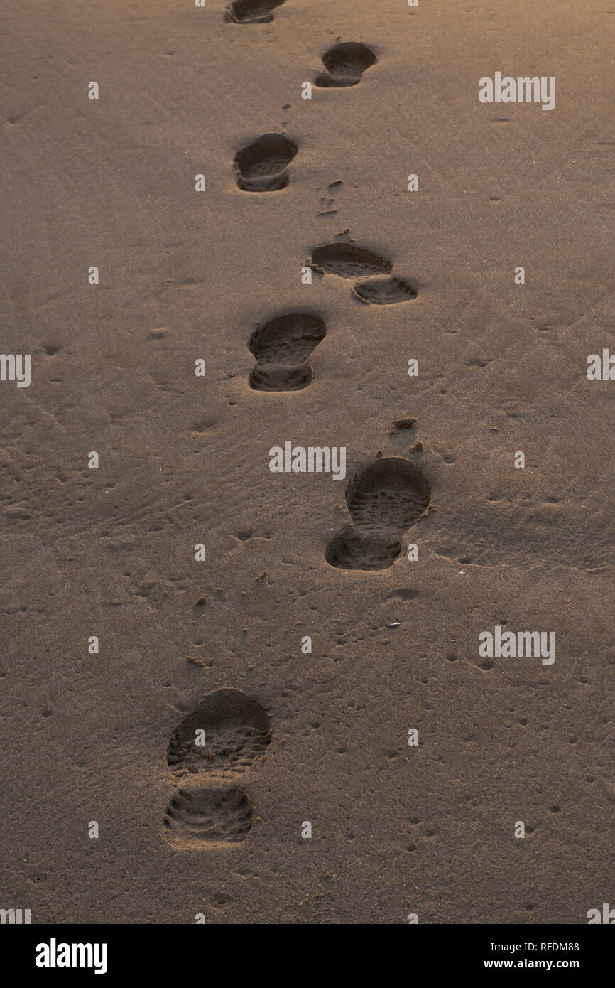 Footsteps on the sand by the beach Stock Photo - Alamy