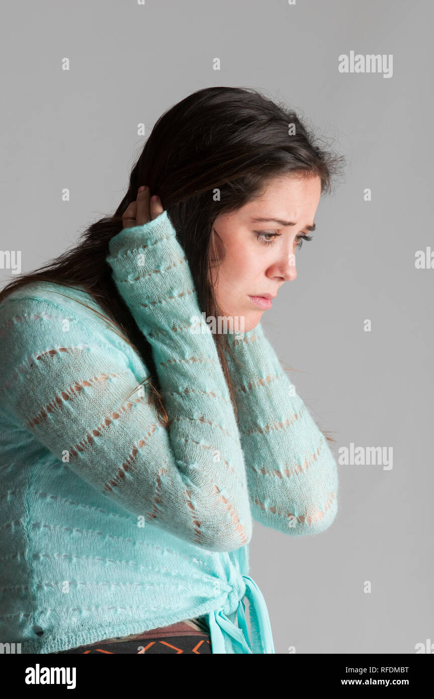 Side view of scared young woman looking away Stock Photo - Alamy