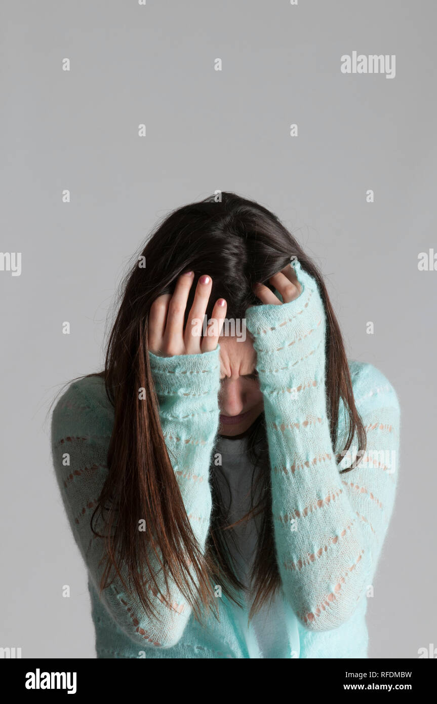 Frustrated young woman head in hands crying Stock Photo - Alamy