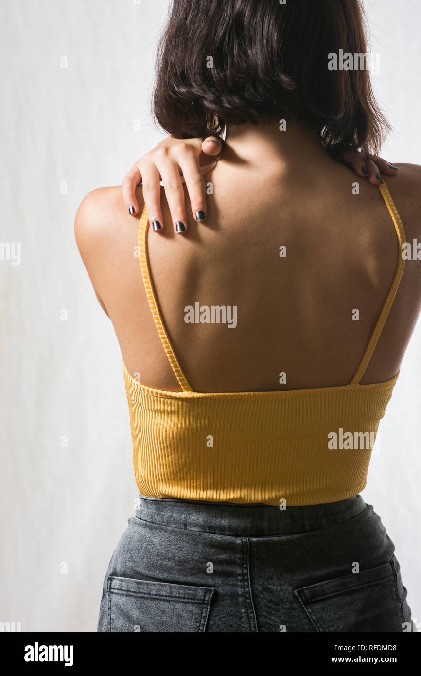 Rear view of a woman hand touching back Stock Photo - Alamy