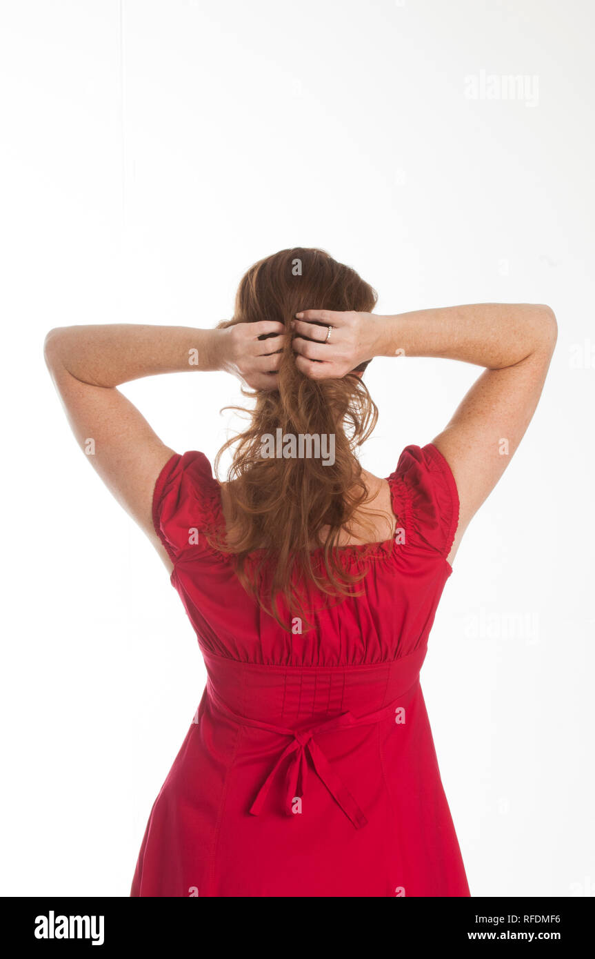 Rear view of woman hand on hair Stock Photo - Alamy