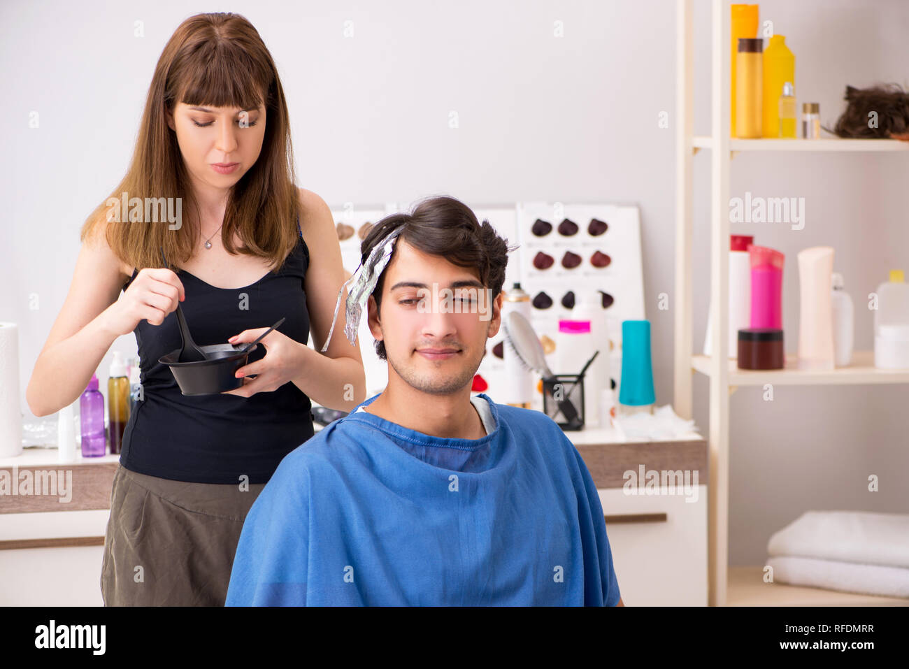 Young attracrive man visiting female barber Stock Photo - Alamy