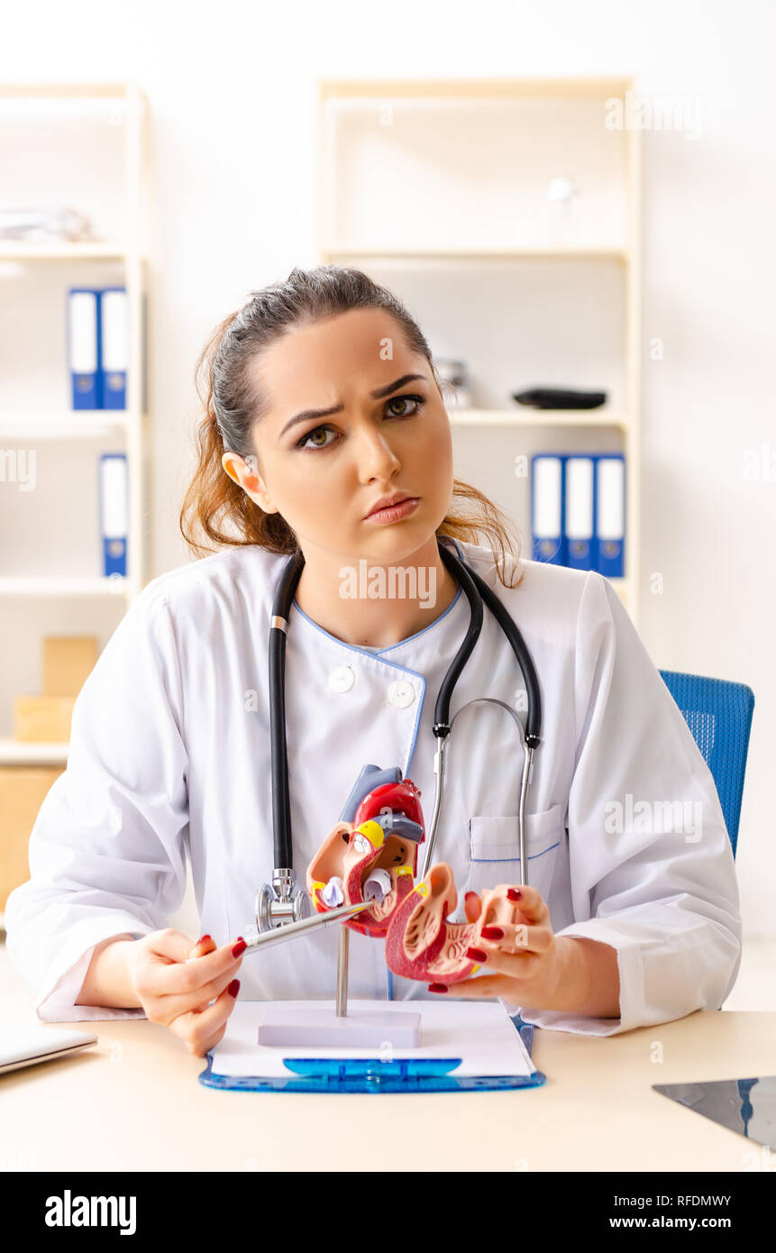 Young female doctor cardiologist sitting at the hospital Stock Photo ...