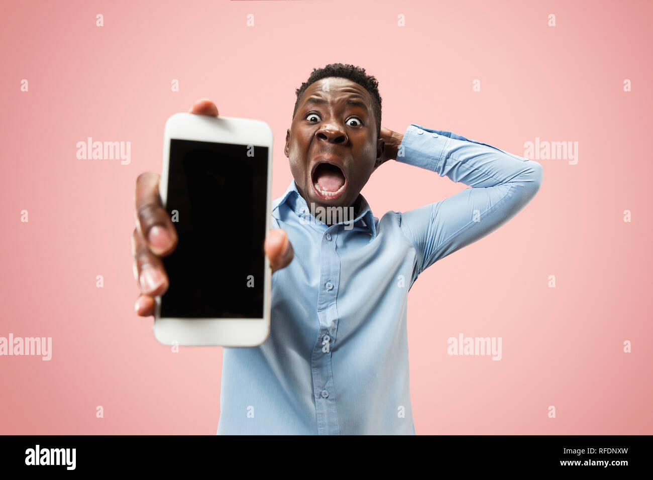 Indoor portrait of attractive young black african man isolated on pink ...