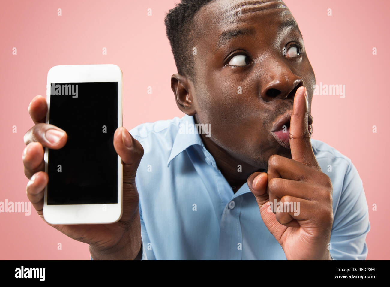 Indoor portrait of attractive young black african man isolated on pink ...