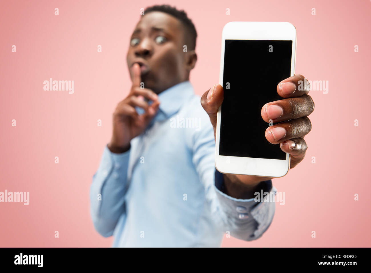Indoor portrait of attractive young black african man isolated on pink ...