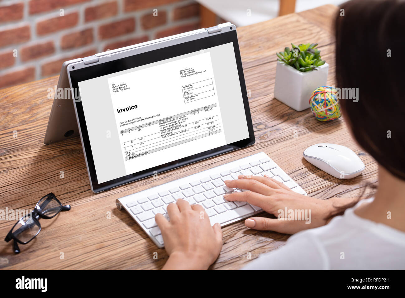 Close-up Of A Businesswoman Filling The Invoice Form On Laptop Over The ...