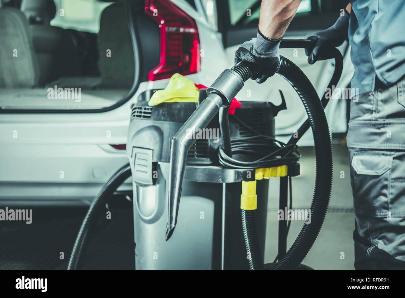 Cleaning Modern Car Interior. Auto Service Worker with Commercial Grade ...