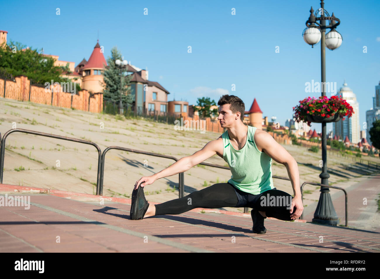 Find balance. Man workout outdoors urban background. You should stretch ...