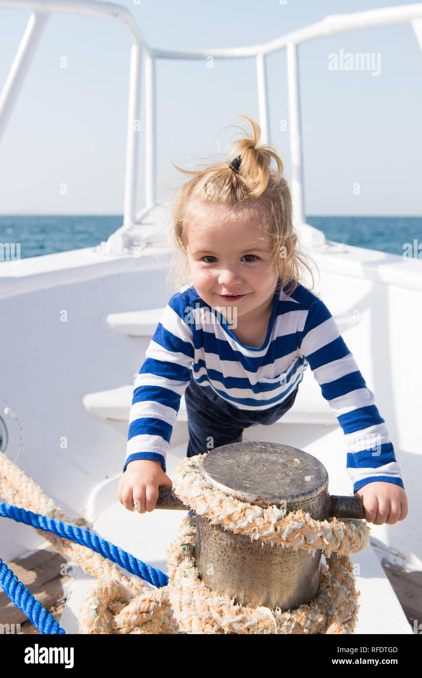 Mooring ship. Child cute sailor help with ropes yacht bow. Adventure ...