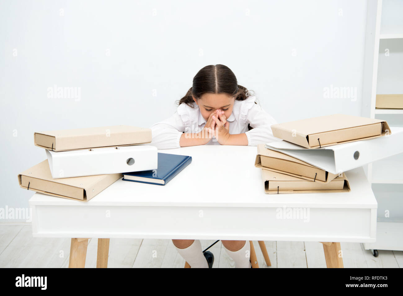 So nervous about coming test. Girl child reads book while sit table ...