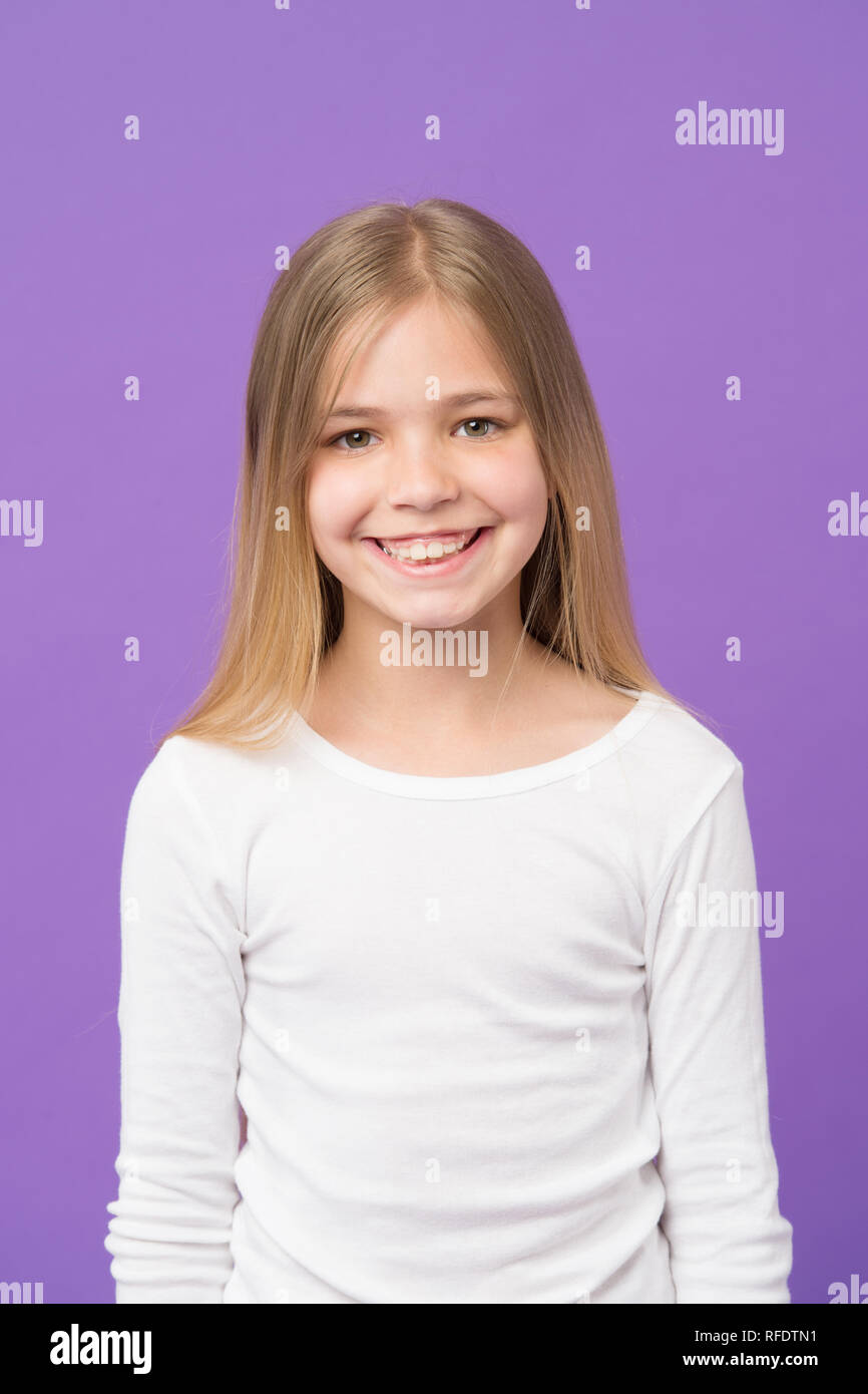 Little girl smile on violet background. Child with fresh skin on cute ...