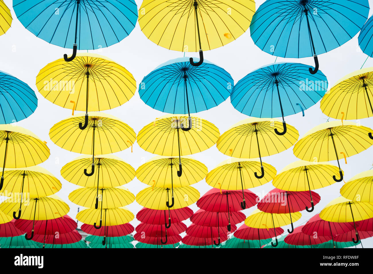 Umbrella sky project installation. Umbrellas float in sky on sunny day ...
