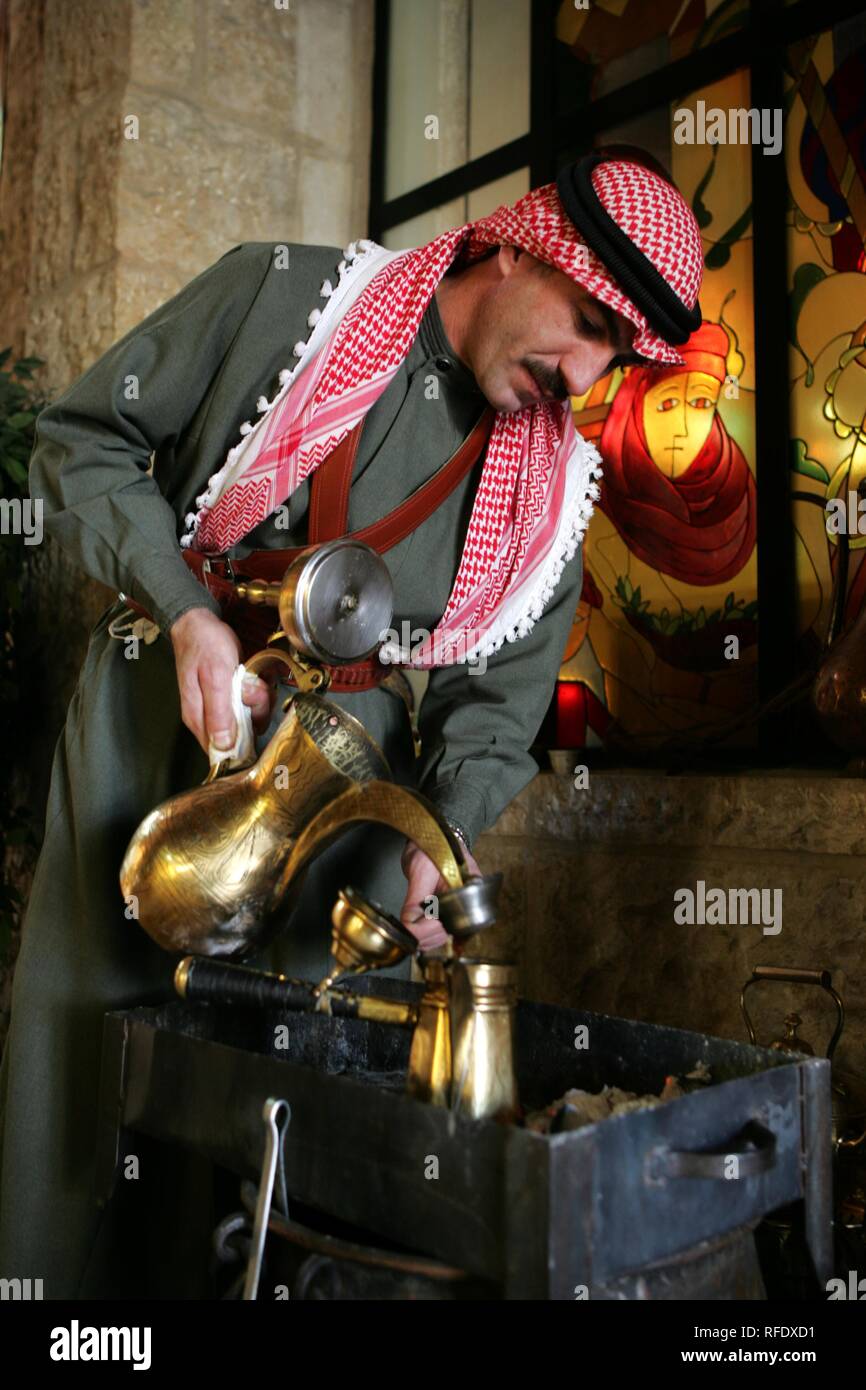 Making of traditional arabian coffee with cardamom, Qahwa masbuta ...