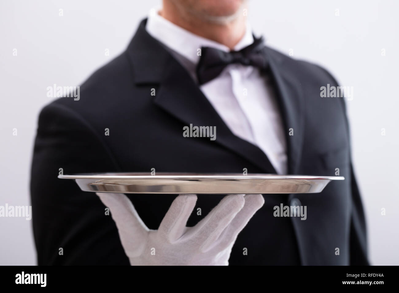 Close-up Of Waiter's Hand Holding Empty Silver Tray Against White ...