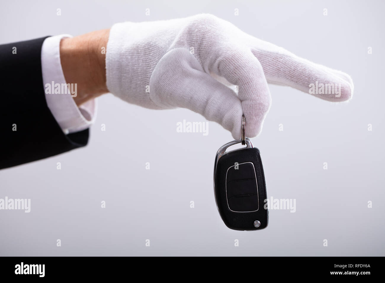Valet's Hand Holding Car Key Against White Background Stock Photo - Alamy