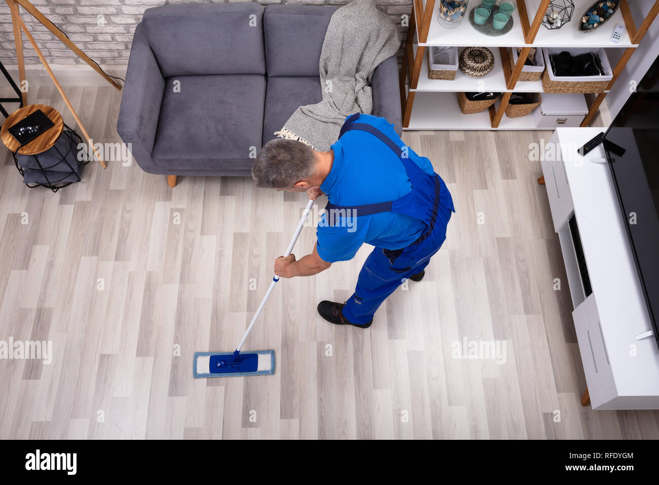 Mature Male Janitor Cleaning Floor With Mop At Home Stock Photo - Alamy