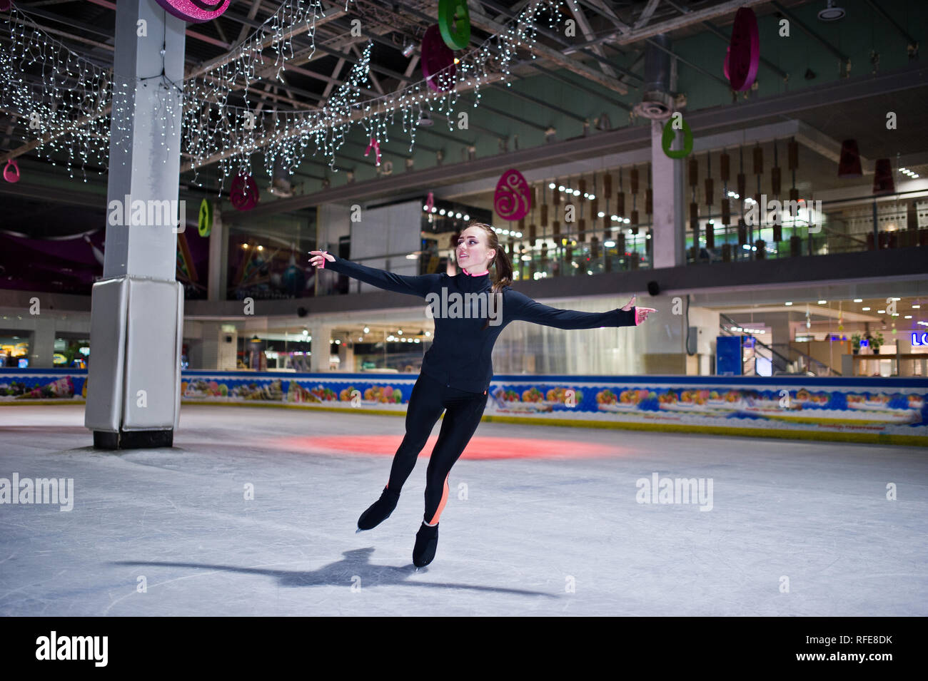 Figure skater woman at ice skating rink Stock Photo - Alamy