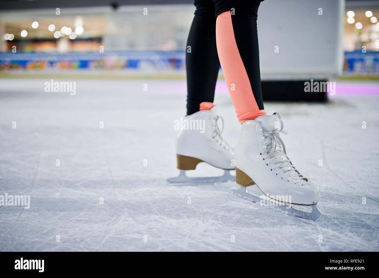 Legs of ice skater on the ice rink Stock Photo - Alamy