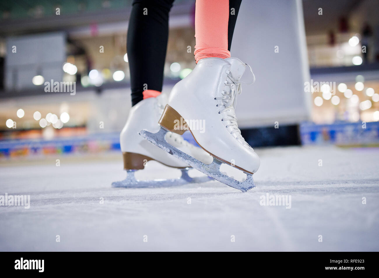 Legs of ice skater on the ice rink Stock Photo - Alamy