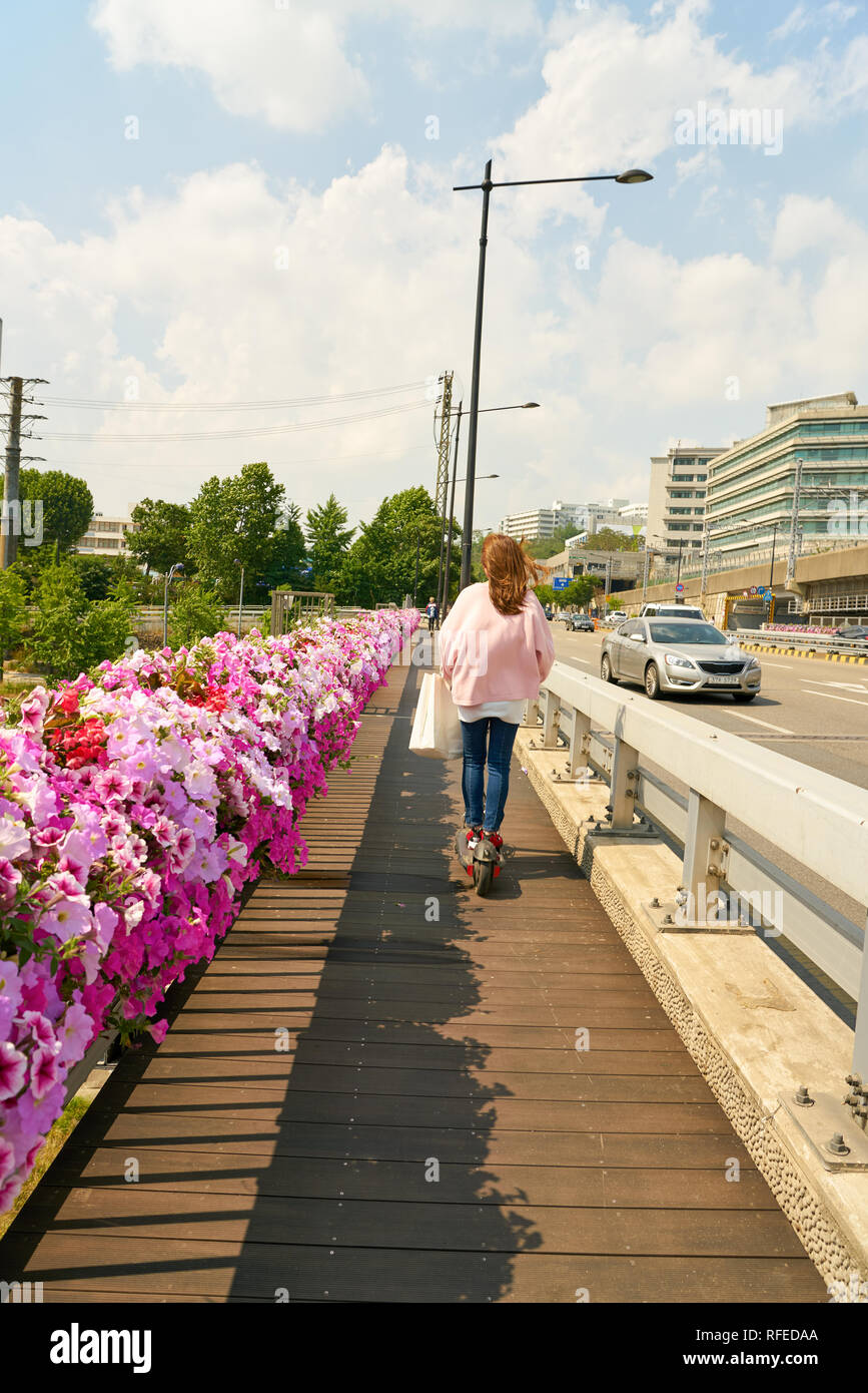 SEOUL, SOUTH KOREA - CIRCA JUNE, 2017: woman crossing bridge in Seoul ...