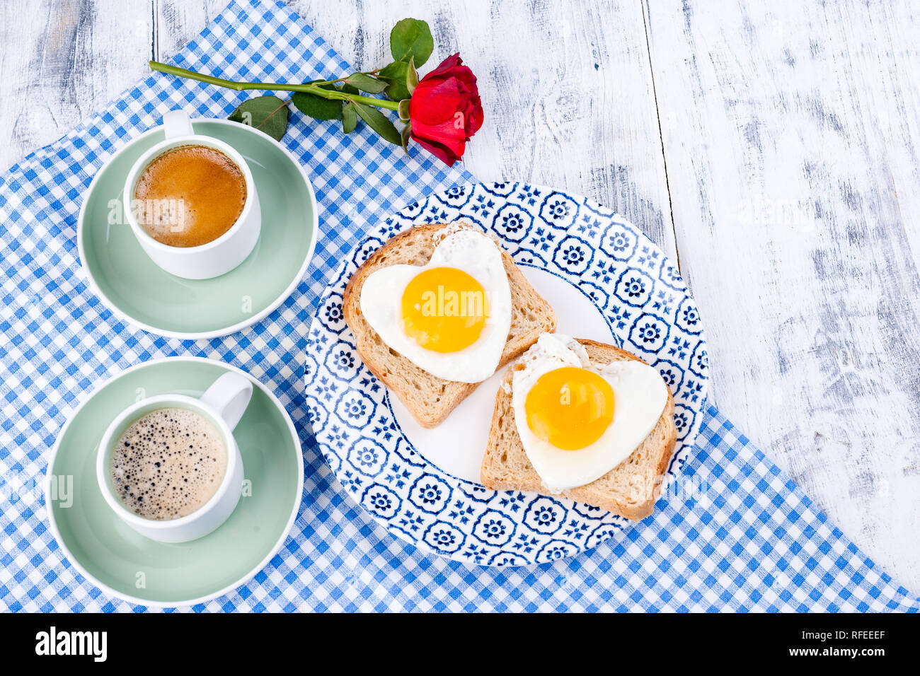 Two cups of aromatic coffee and heart-shaped toasts for a romantic ...
