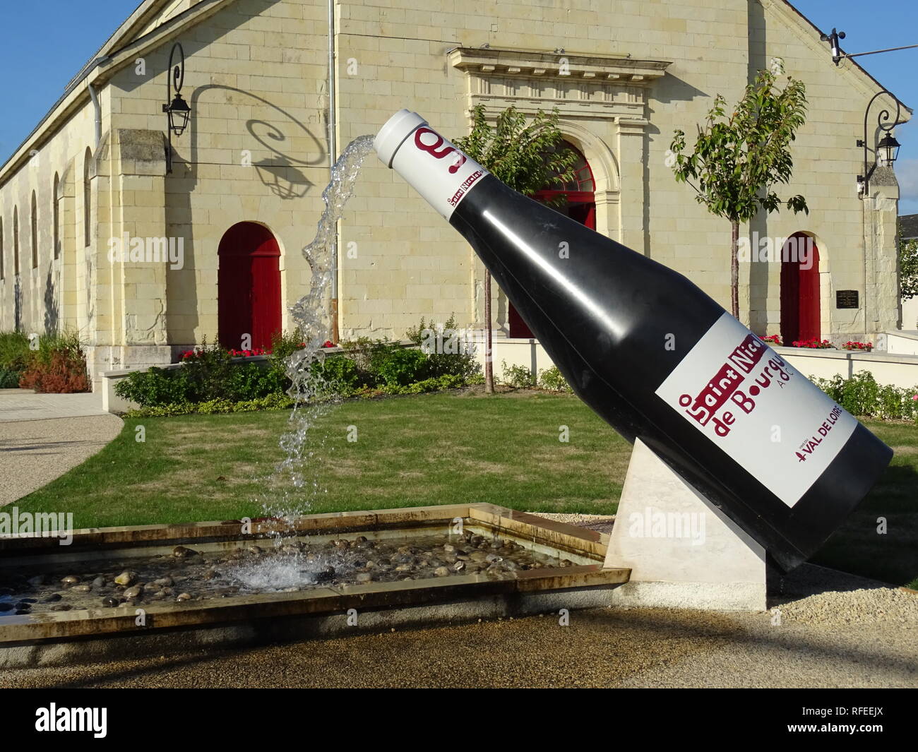 Fun wine bottle fountain in front of a church in the country side in ...