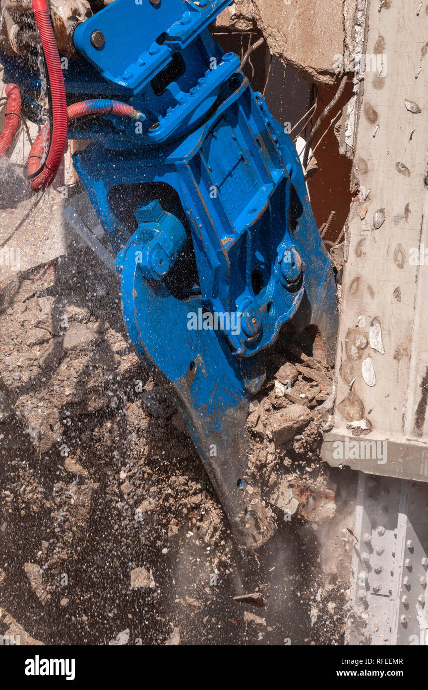 Hydraulic concrete shears in action when deconstructing a building ...