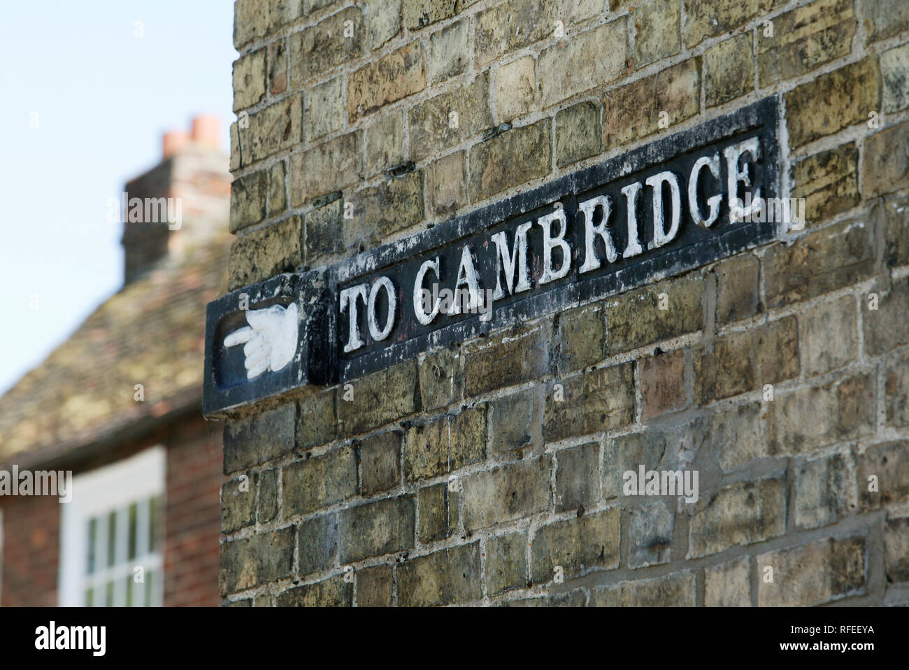 Old style design hand and finger street road traffic sign on a brick ...