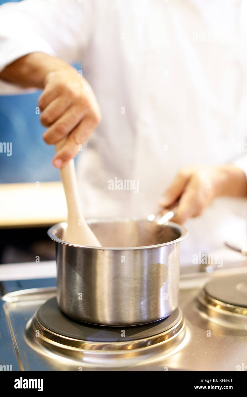 Chef cooking food in the kitchen, Chef preparing food Stock Photo - Alamy