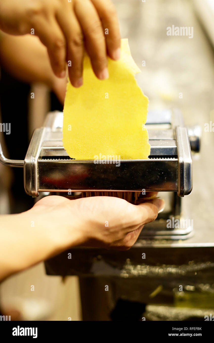 Chef making pasta with a machine, home made fresh pasta Stock Photo - Alamy