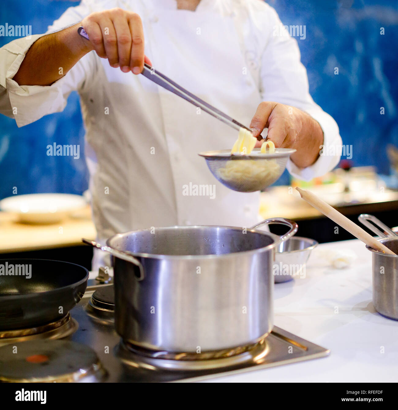 Chef cooking spaghetti in the kitchen Stock Photo - Alamy