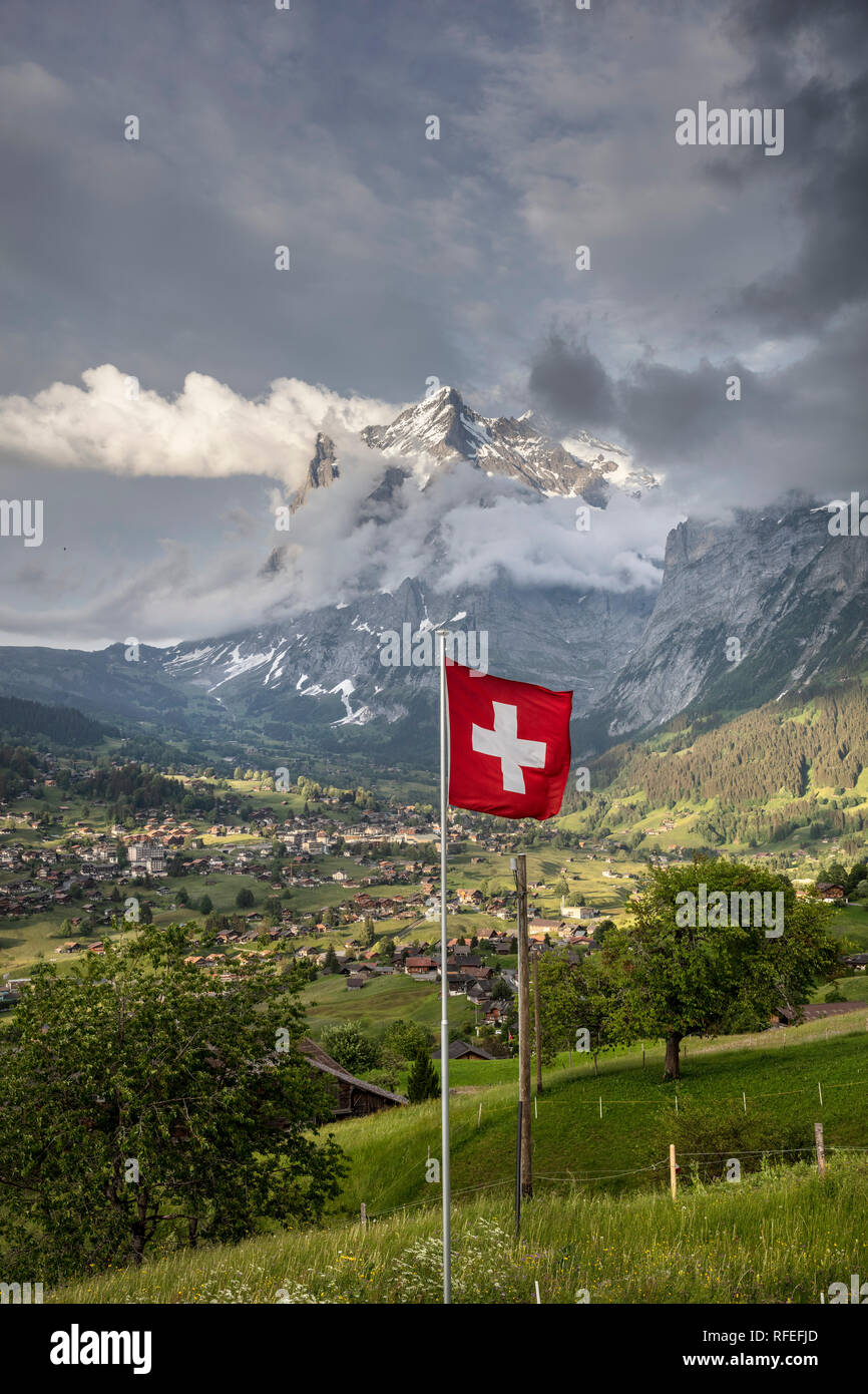Switzerland, Alps, Berner Oberland, Grindelwald, Spring. Swiss flag ...