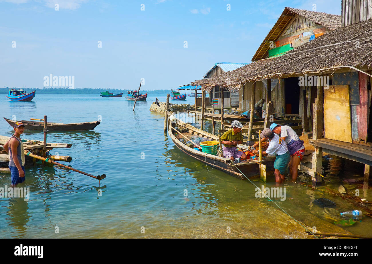 CHAUNG THA, MYANMAR - MARCH 1, 2018: The group of villagers reapirs an ...