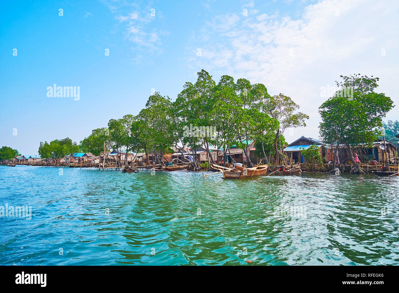 The boat trip along the line of fishing village huts and mangroves on ...