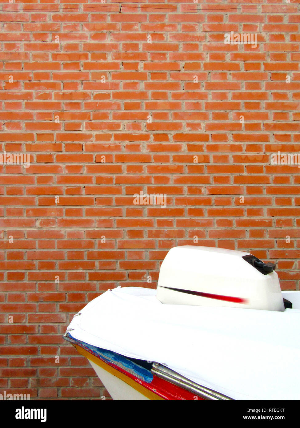 white poop boat against brick wall background Stock Photo - Alamy