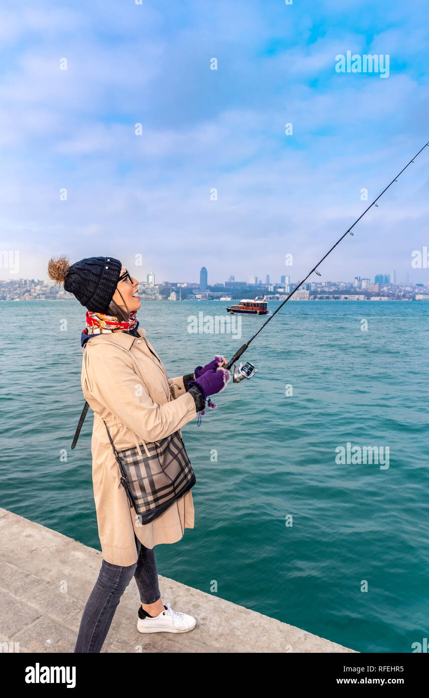 Beautiful woman catches fish at Bosphorus,a popular destination in ...