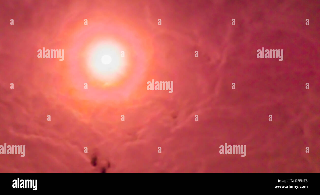 red cloudy sky with a bright sun shining through the clouds, hopeful ...