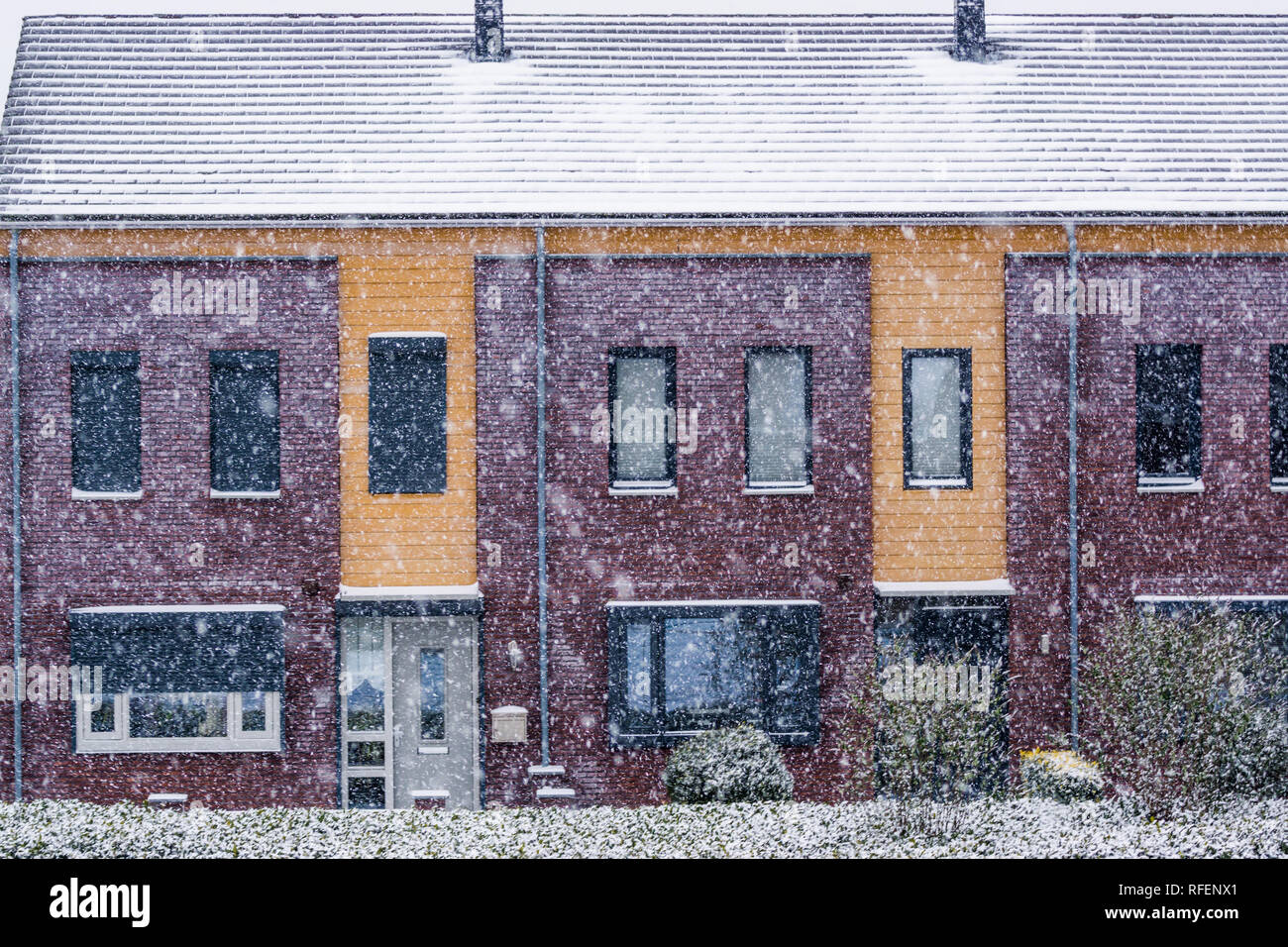 Modern dutch terraced homes during a cold winters day, snowy weather in ...